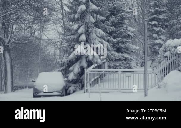 Snowy path with car. Winter landscape with falling snow. Everything is ...