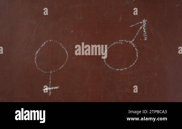 Textured brown chalkboard background. Male hand drawing equals sign ...