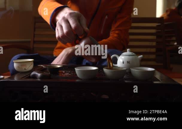 Man Pouring Puer Tea in Teapot at Traditional Chinese Tea Ceremony. Set ...