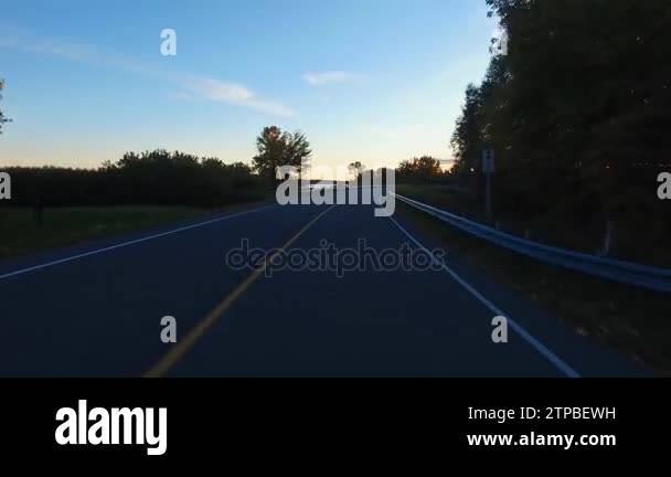 Driving a Car in Point of View Perspective on a Road at Sunset ...