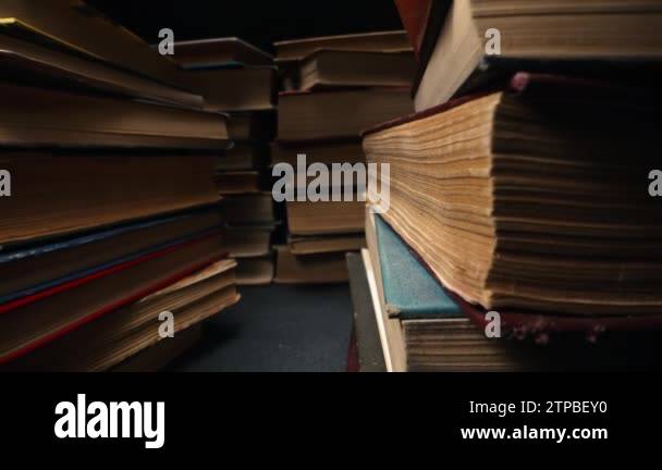 Library stack of old books, slider macro footage, camera moving between ...