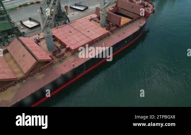 cargo ship or bulk carrier loaded to the brim with grain is preparing ...