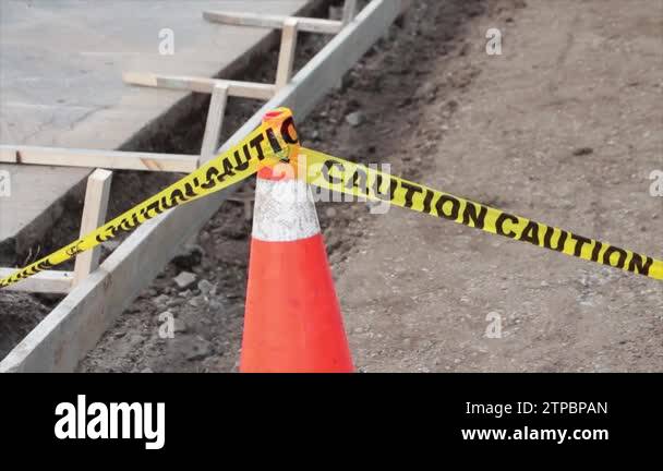 sidewalk construction building dug out up with wood frame and pylons ...