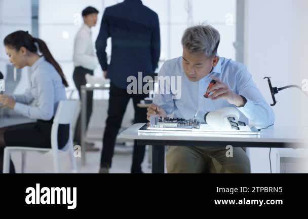 4K Technical design team working on construction of robot in modern lab ...