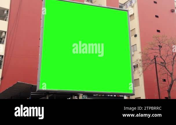 Billboard with Green Screen on a Building. Ready to replace green screen with any footage or ...