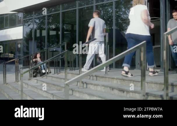 Woman with physical disability rides into clinic entrance on motorized ...