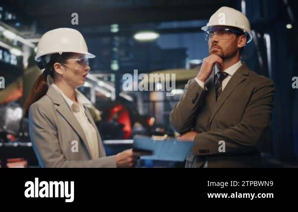 Two partners inspecting production heavy industrial manufacturing ...