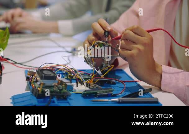 Man Using Multimeter to Measure Voltage of the Motherboard Sitting in ...