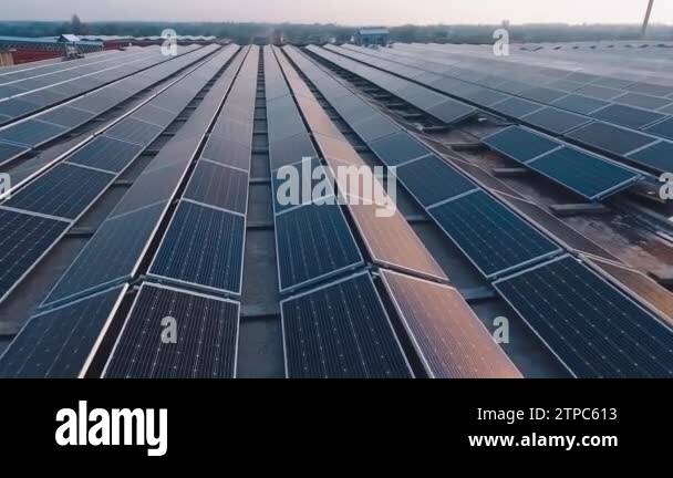 Rows of sunny panels on the roof. The setting sun reflects on sunny ...