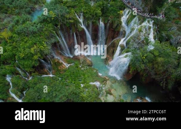 Powerful waterfall flows into a lake with azure clear water. Plitvice ...
