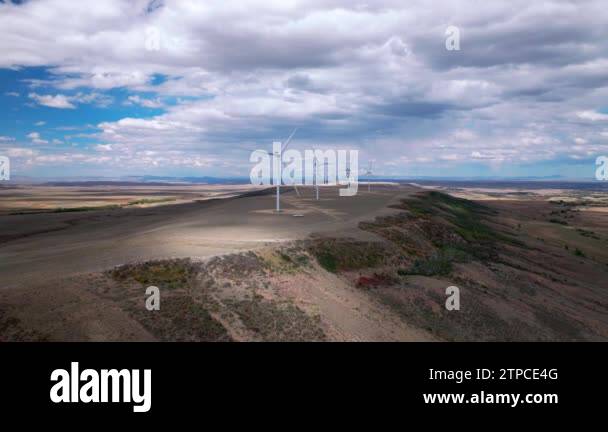 Desert Wind Power: Spinning Turbines in Azure Skies. 4k footage ...