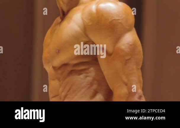 Strong man showing massive muscles in side triceps pose, ripped six ...