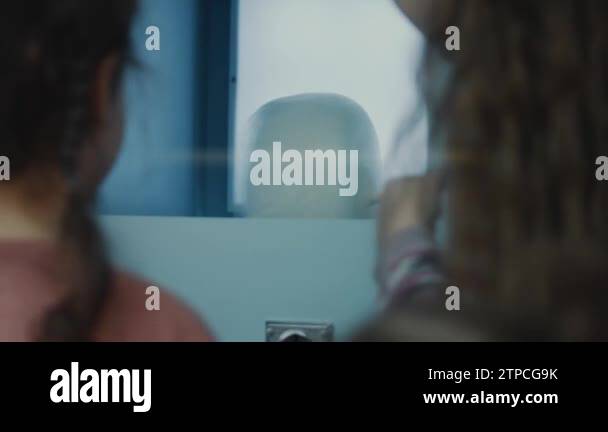 Happy little girls waiting for the automatic cotton candy vending ...