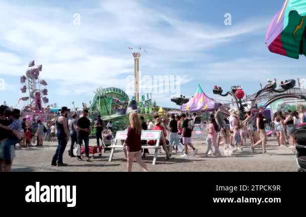 People riding on spinning swing carousel in amusement park Swing rides ...