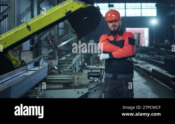 Good looking factory worker with the protective helmet and uniform ...