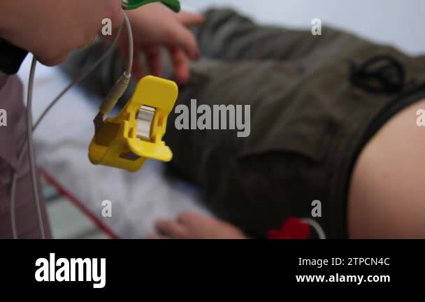 cardiogram in the hospital woman doctor examines a man patient puts ...