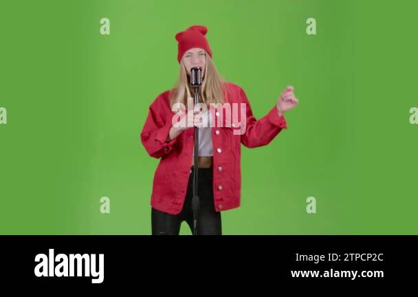Teenager sings on stage in a retro microphone. Green screen Stock Video ...