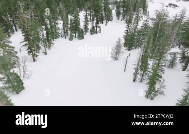 Awesome shot of mountains as man skiing in cinematic Sierra Nevada ...