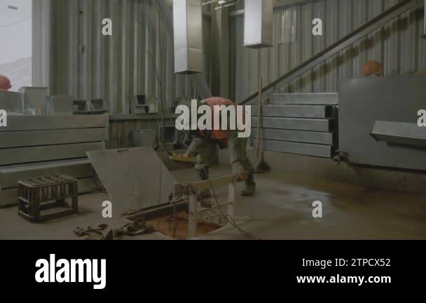 Employee with remote controls cargo transportation looking in floor ...