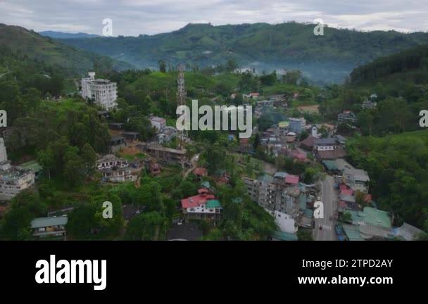 Forwards fly above buildings and streets in small town in beautiful ...