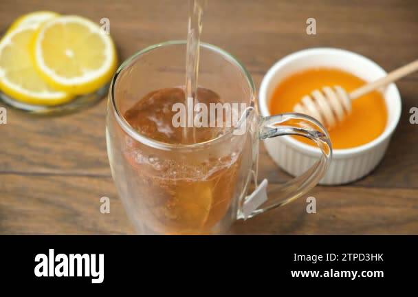 Preparation of packaged black tea, boiling water is poured into a cup ...