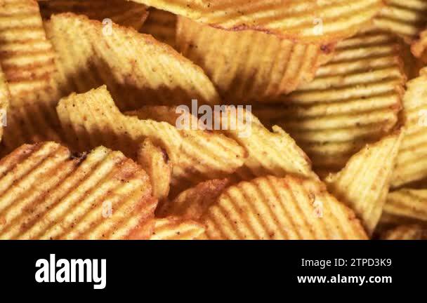 A bunch of golden chips rotates in a circle, Golden potato chips are ...
