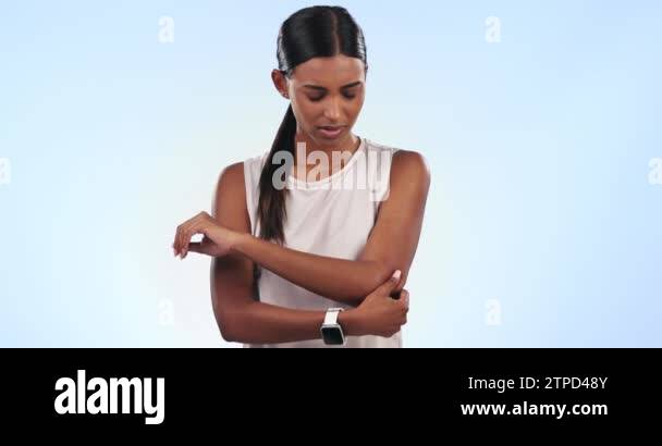 Injury, arm and woman with fitness, pain and inflammation on a blue ...
