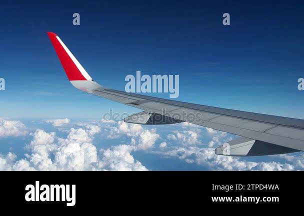 Zoom out of the wing aircraft flying in the sky. The tip of the wing is ...