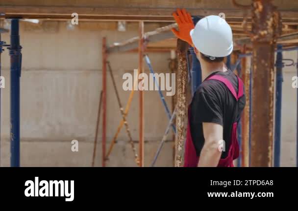 Following side shot of Professional Construction Worker Wearing Hard ...