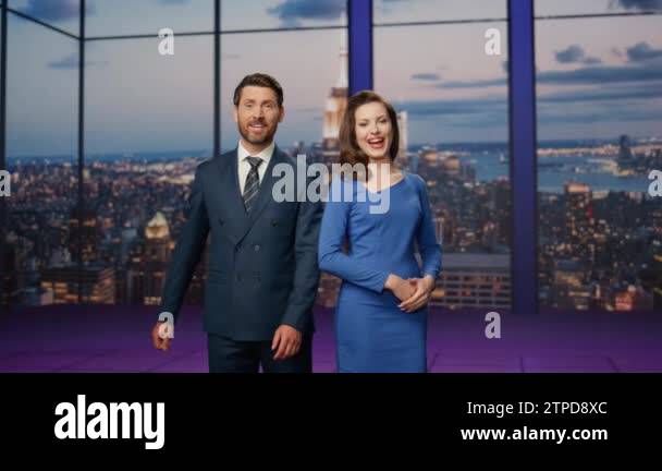 Team reporters greeting in live news studio starting broadcast in air ...