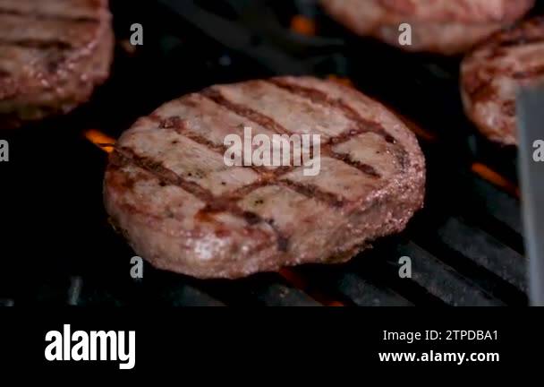 barbecue for a hamburger cooked on an open fire and turned over meat ...