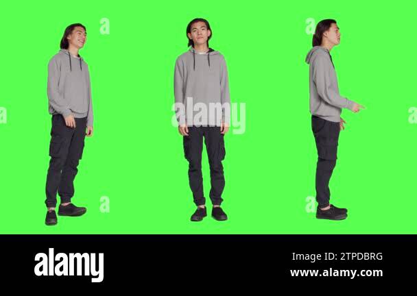 Asian adult shows agreement symbol over greenscreen full body ...