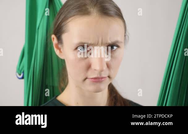 Portrait of young beautiful fly yoga coach upset and angry. Aerial aero ...