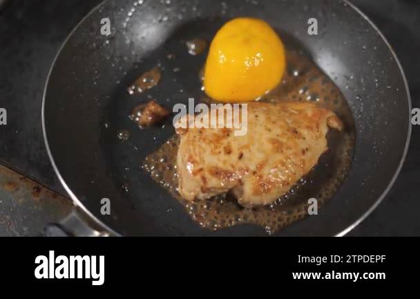 Cooking with fire in frying pan. chicken breast. Professional chef in a ...