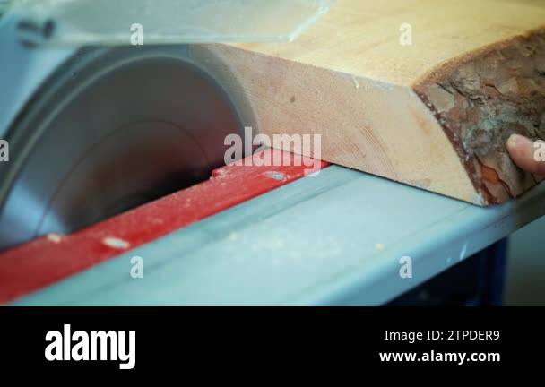 Cutting wood at a wood factory. Close up clips of sawing wood. A ...