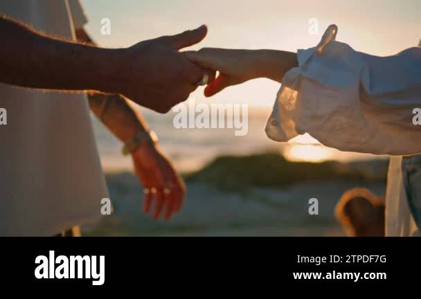 Love couple connecting hands at bright sun sea beach closeup ...