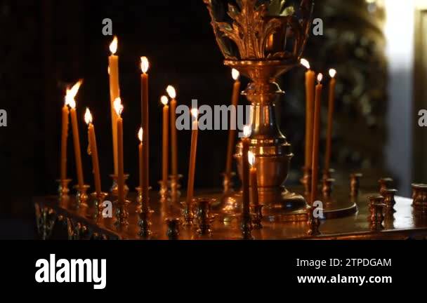 Burning church wax candles in a candlestick, close up. Concept of ...