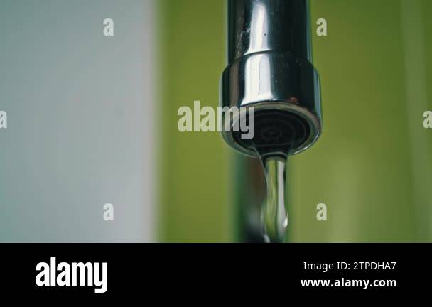 Close-up of water flowing from a kitchen faucet. drinking water from ...