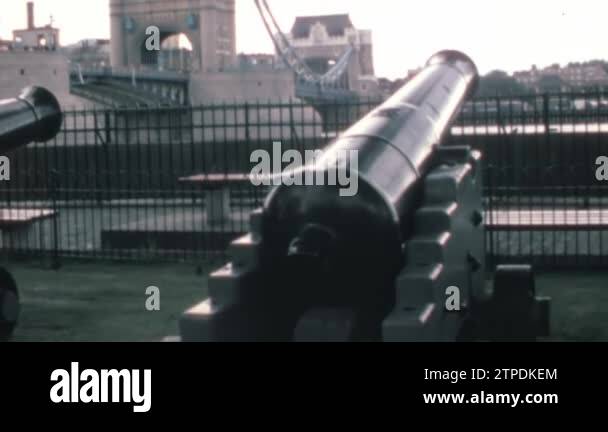 Close-up of a historical cannon with the famous Tower Bridge in ...
