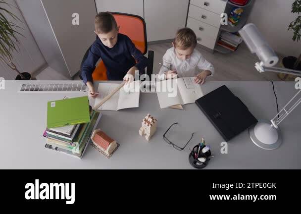 Two students do homework at home. The guys draw designs for houses that ...