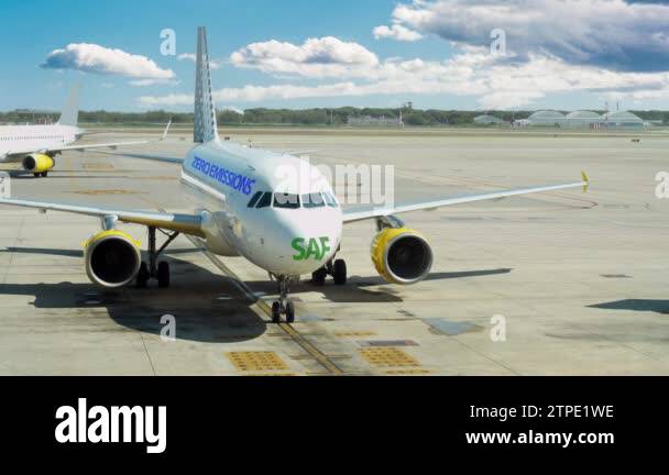 Commercial aircraft at airport with SAF text and zero emissions ...