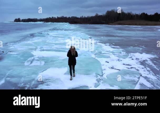 Lake , girl walking on frozen lake, Girl walking on cracked ice of a ...