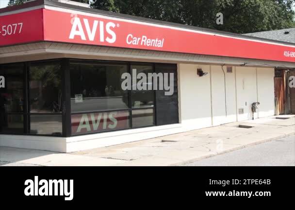 avis car rental store business company on bright day with windows ...