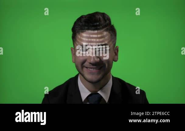 Happy smiling male computer hacker dressed in formal clothes using ...