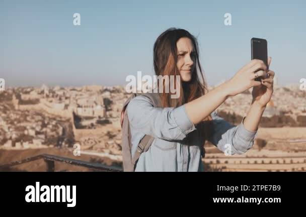 Pretty girl takes selfie in Jerusalem old town. Cute local girl smiles ...