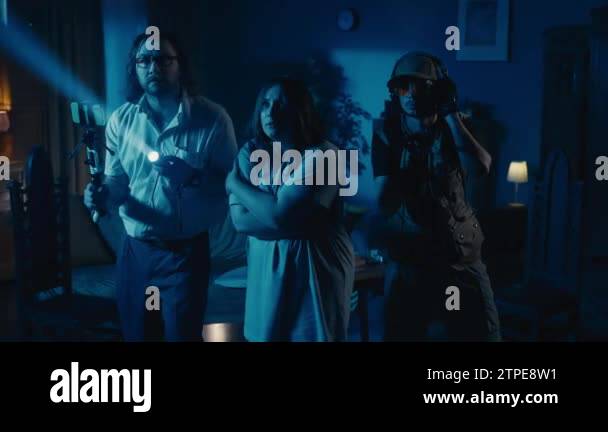 Zoom in video capturing two ghost hunters and a victim going around the ...