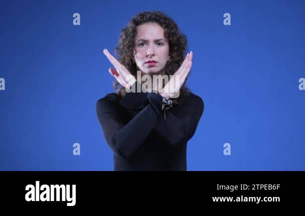 Woman rejecting offer to camera, saying "NO" with body language ...
