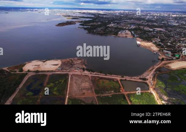 Sand extracting quarry and evaporation ponds near tranquil river bay ...