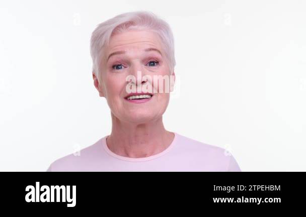 Mature woman wears an expression of genuine astonishment, eyes wide and ...