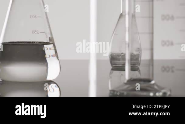 Video of close up of glass laboratory beakers and dishes with copy ...